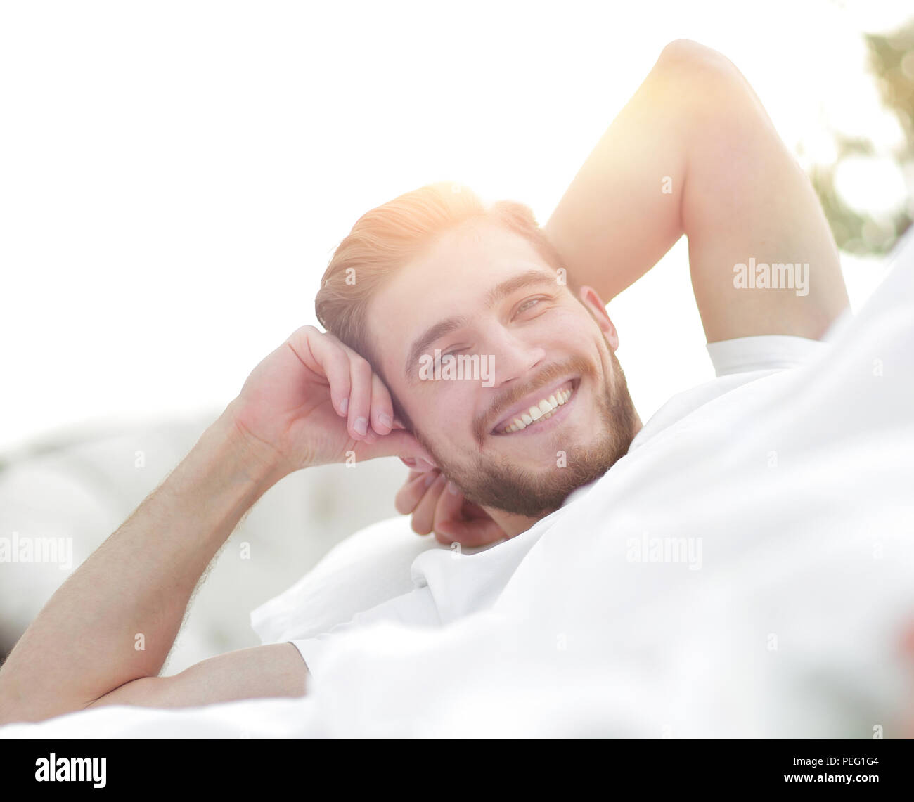closeup.smiling man resting in the bedroom Stock Photo - Alamy