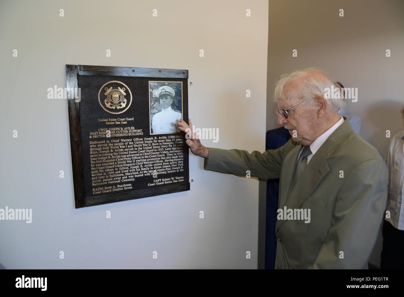 Joseph Avilés Jr. places the plaque for the new Chief Warrant Officer ...