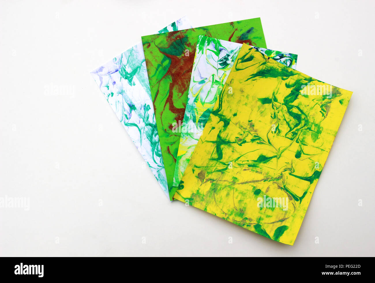 multi-colored handmade marble papers on white background, do it ...