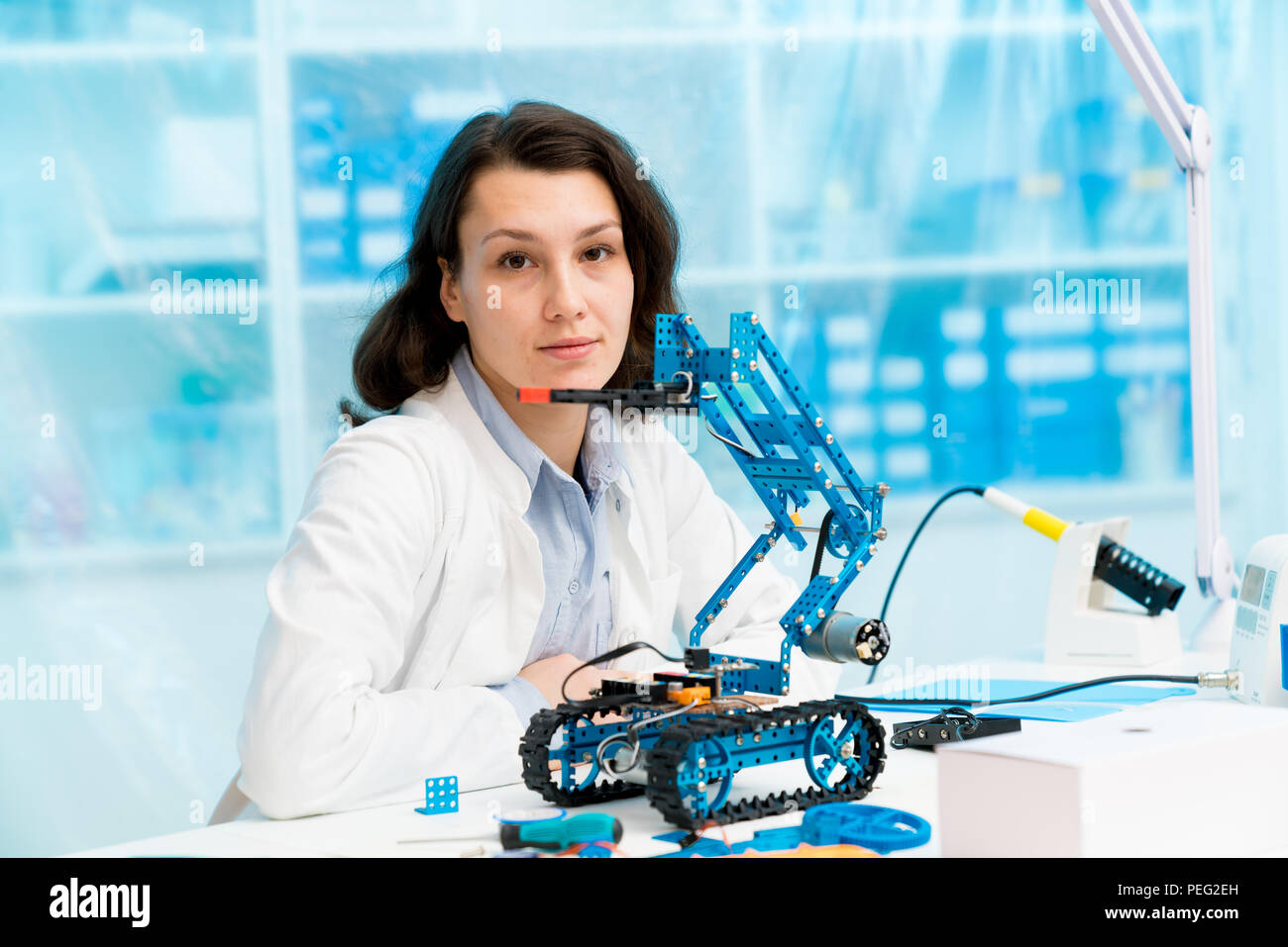 Student girl in electronics laboratory, experiment with microcontroller ...