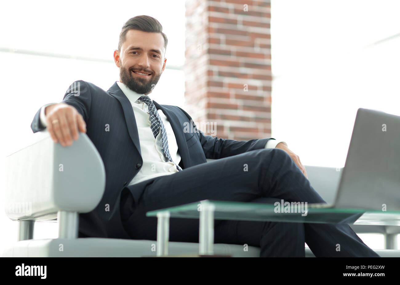 Portrait of a successful businessman sitting in the office lobby Stock ...
