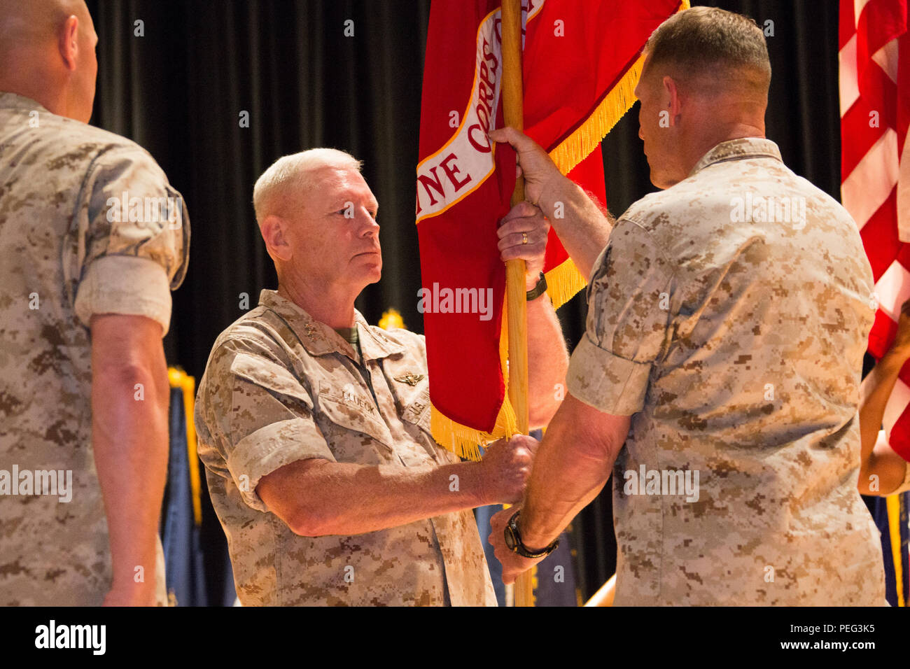 Lt. Gen. Kenneth J. Glueck, Jr., center, transfers the unit's flag to ...