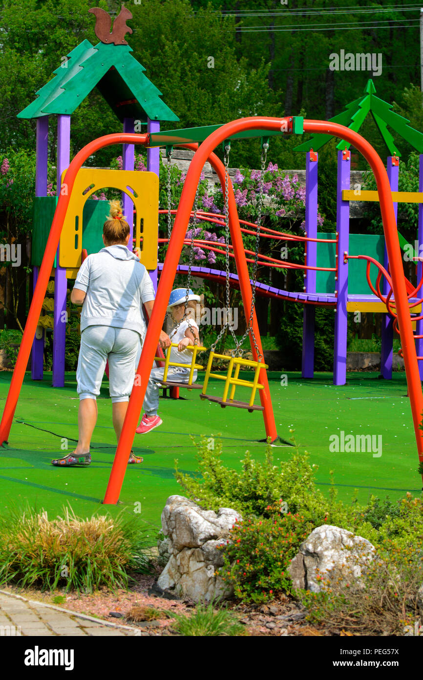 Little children run around and play in the playground. Game center for ...