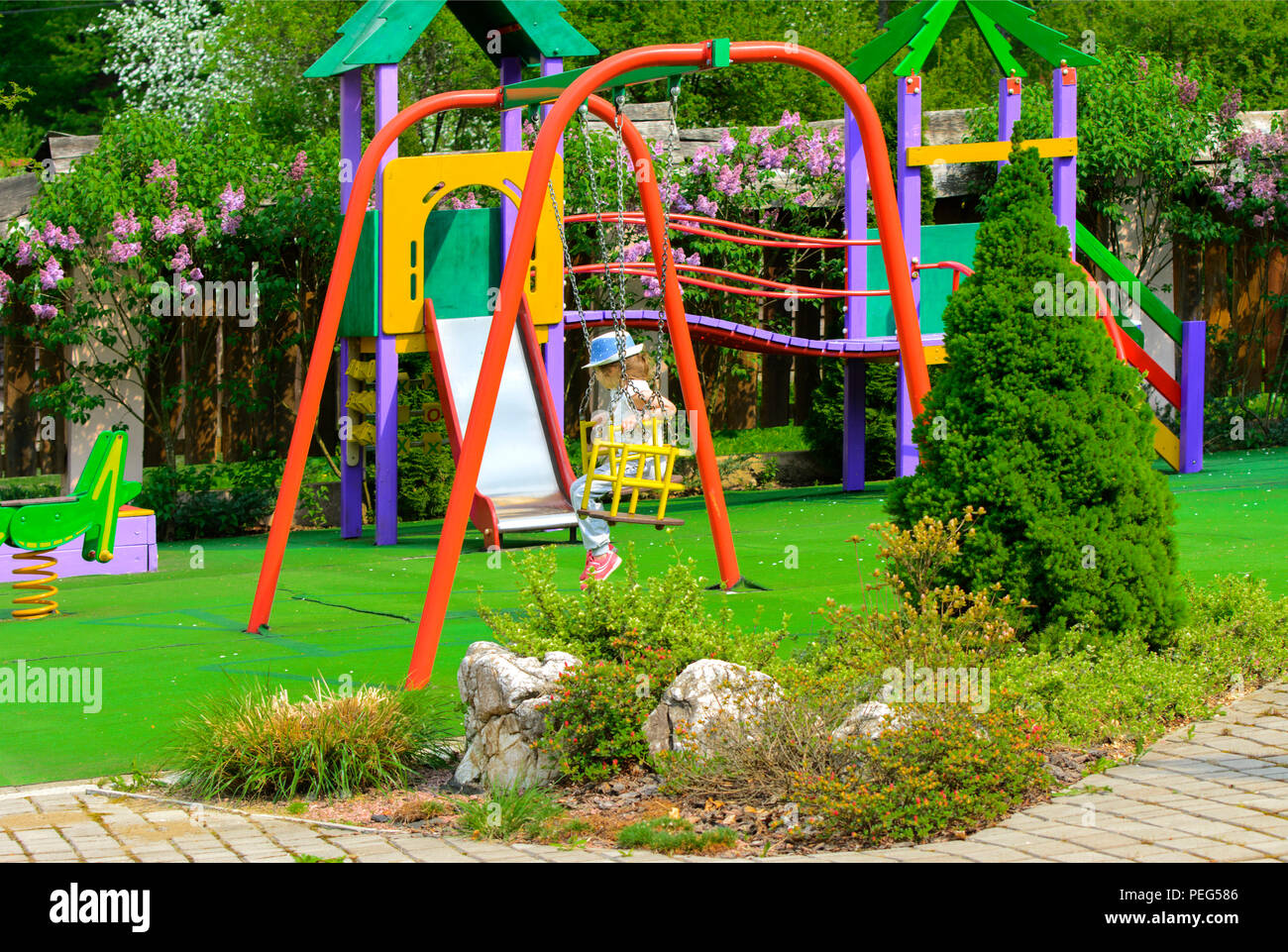 Little children run around and play in the playground. Game center for ...