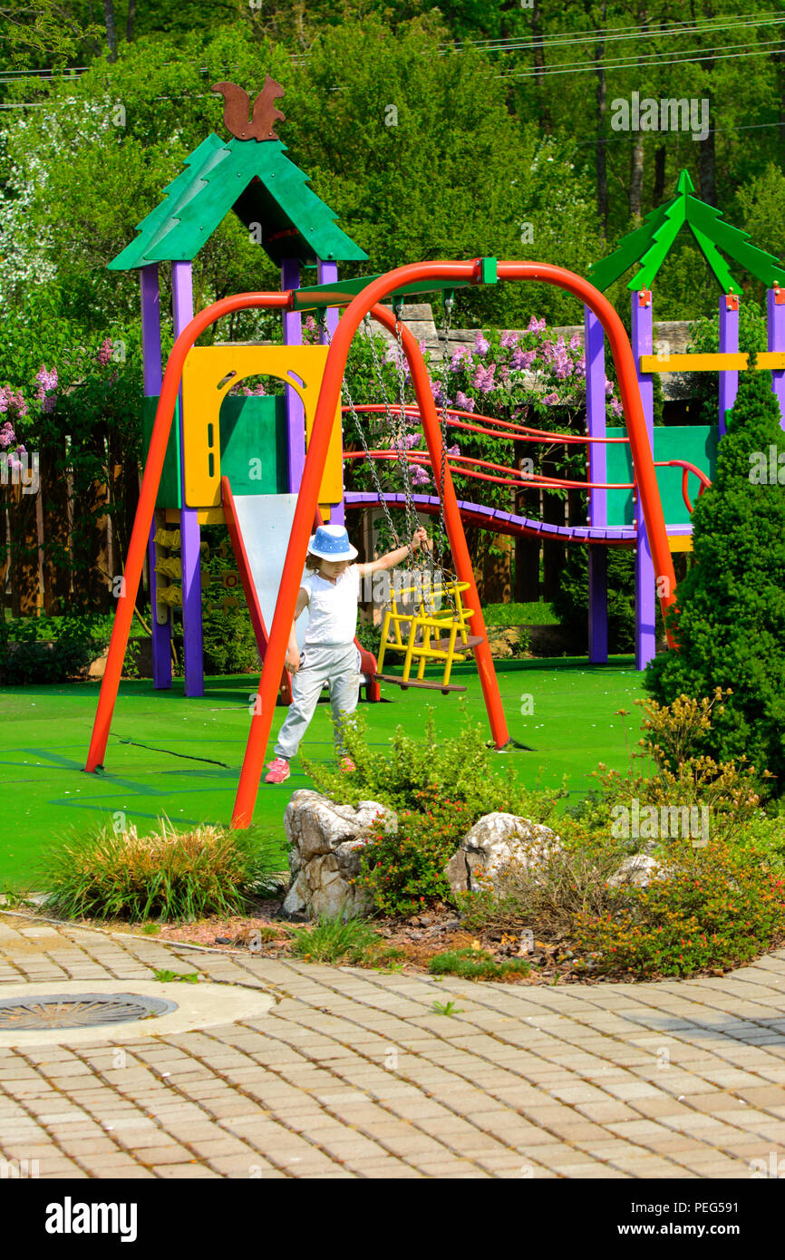 Little children run around and play in the playground. Game center for ...