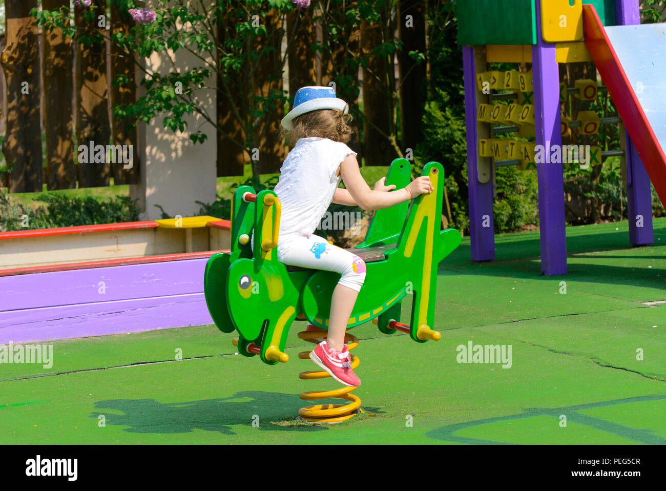 Little children run around and play in the playground. Game center for ...