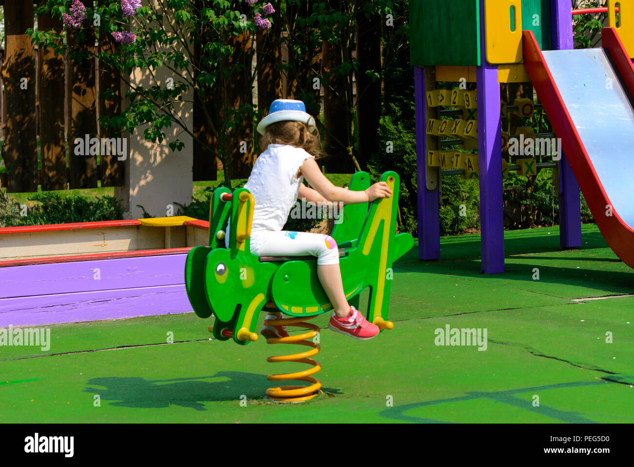 Little children run around and play in the playground. Game center for ...