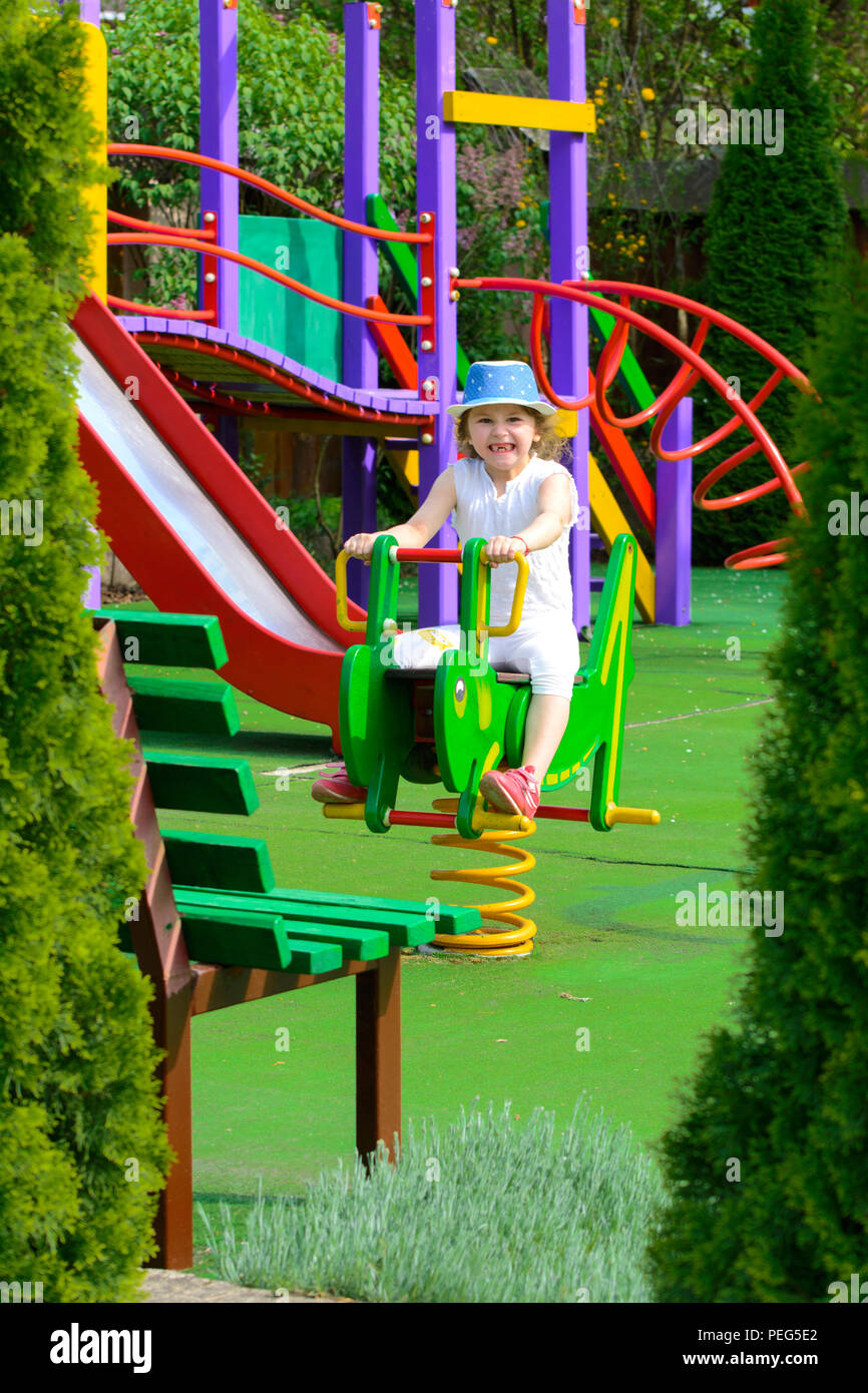 Little children run around and play in the playground. Game center for ...