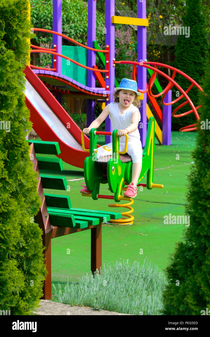 Little children run around and play in the playground. Game center for ...
