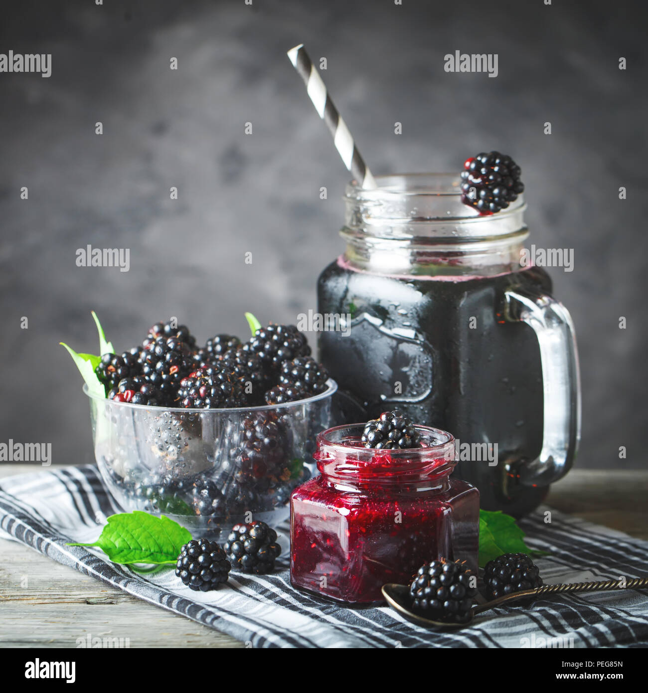 Ripe blackberry, blackberry juice and jam on a wooden table. Dark ...