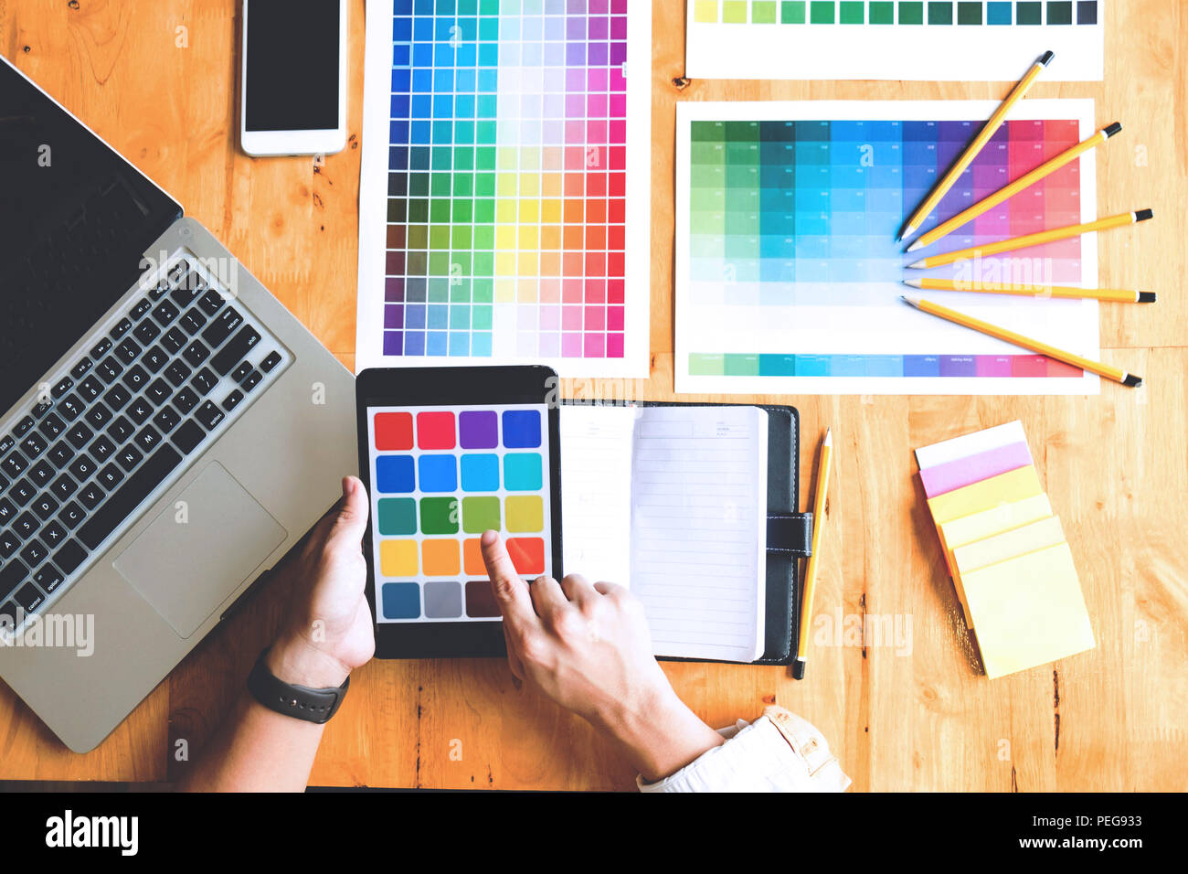 Graphic designers use the tablet to choose colors from the color bar ...