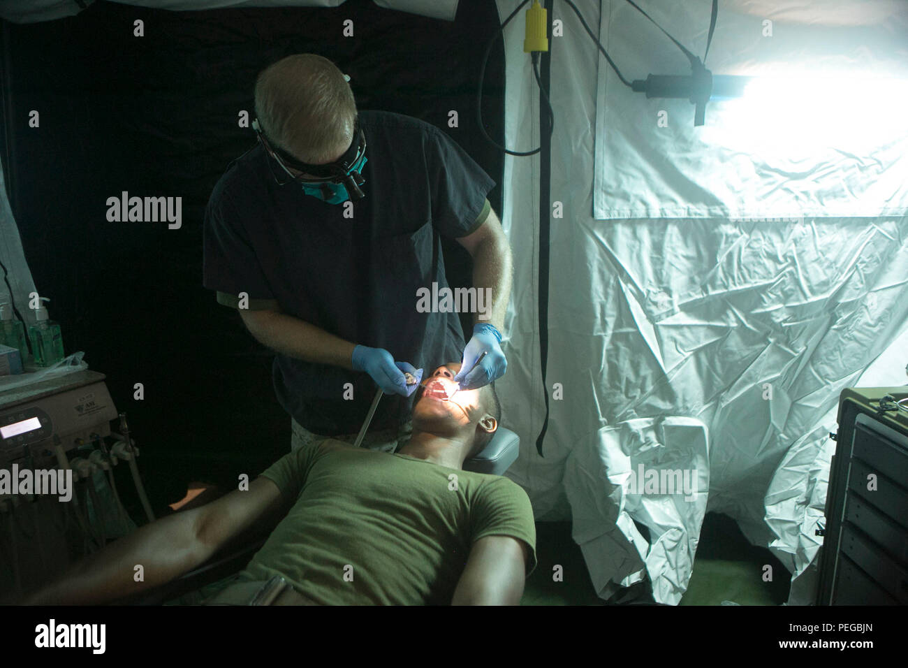 Navy Lt. James Shaul, a dentist with 2nd Dental Battalion, conducts an ...