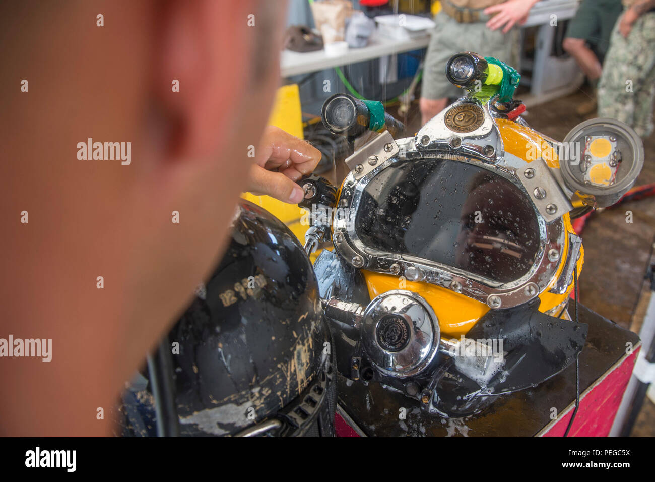 A Navy diver from Mobile Diving and Salvage Unit 2 conducts pre-dive ...