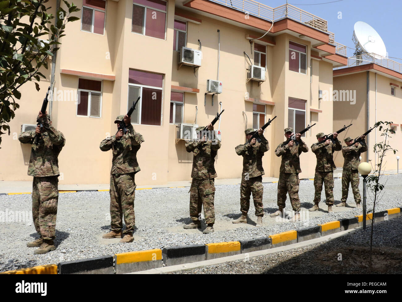 U.S. Army Soldiers fire a three-volley salute during a memorial ...
