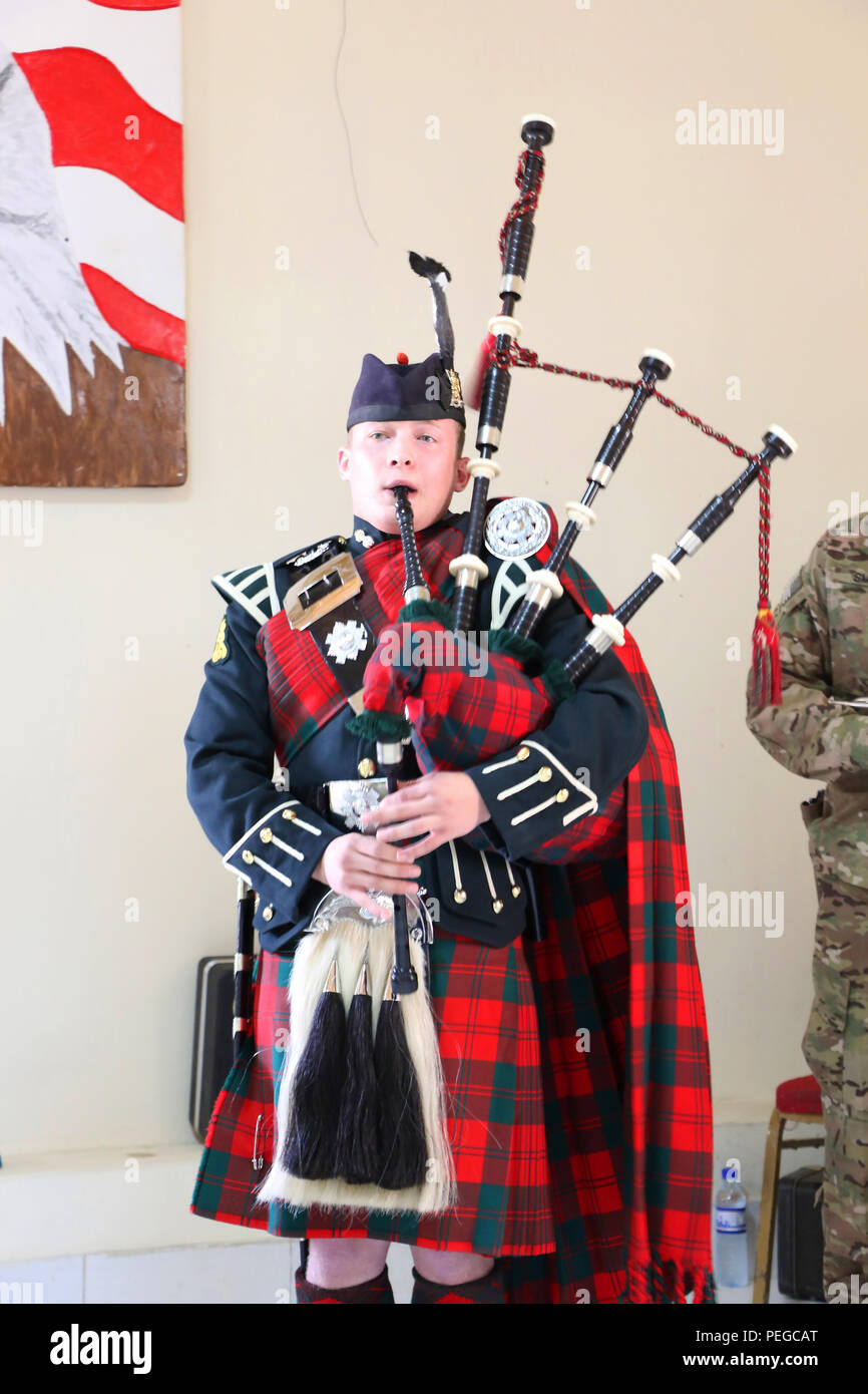 A bagpiper plays for coalition forces joined together Aug. 13 to ...
