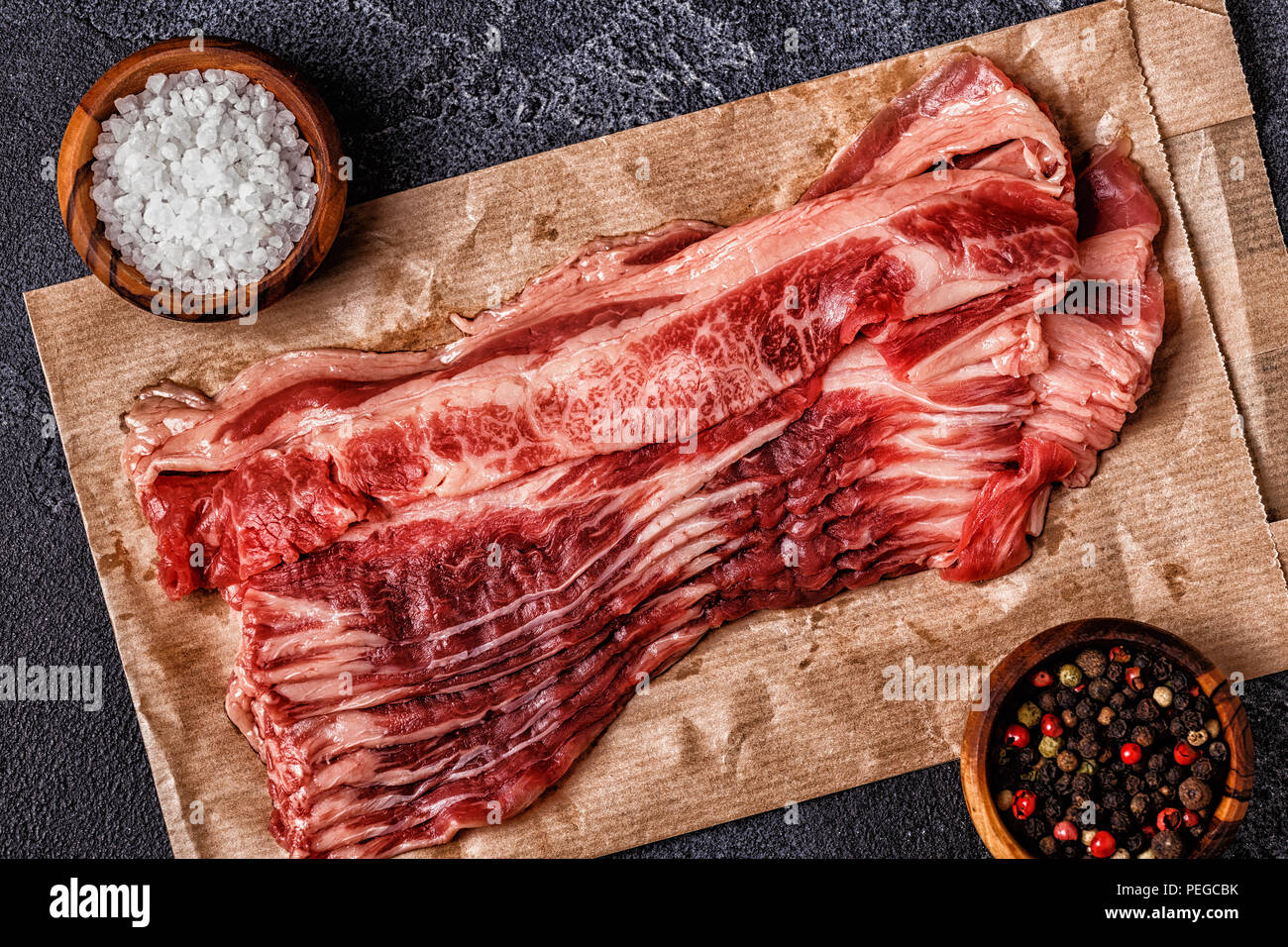 Portion of raw Bacon stripes on dark background, top view Stock Photo ...