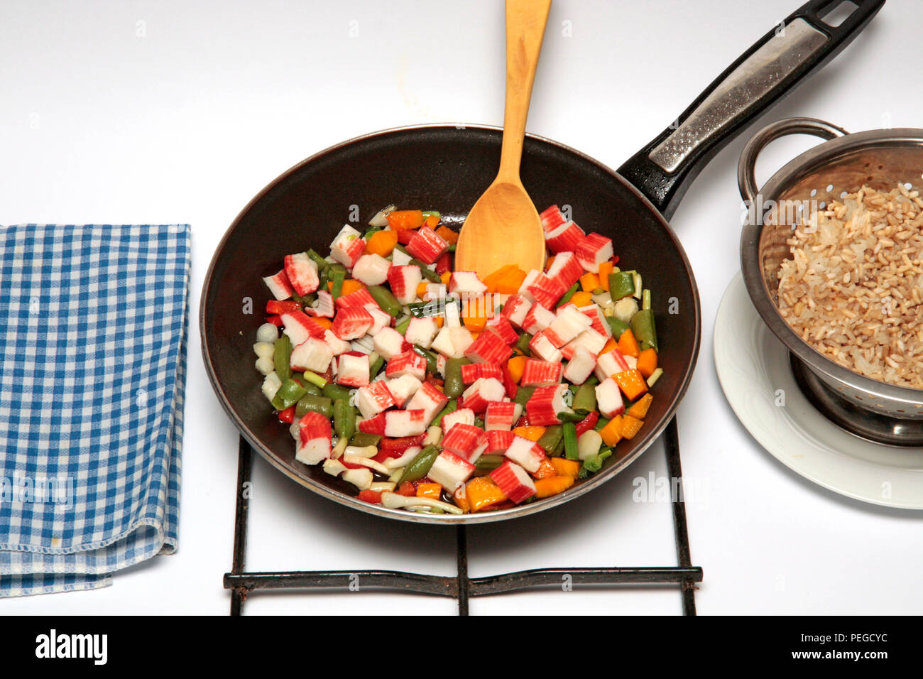 Wholemeal rice with surimi and vegetables. Step by step. Prepared dish ...