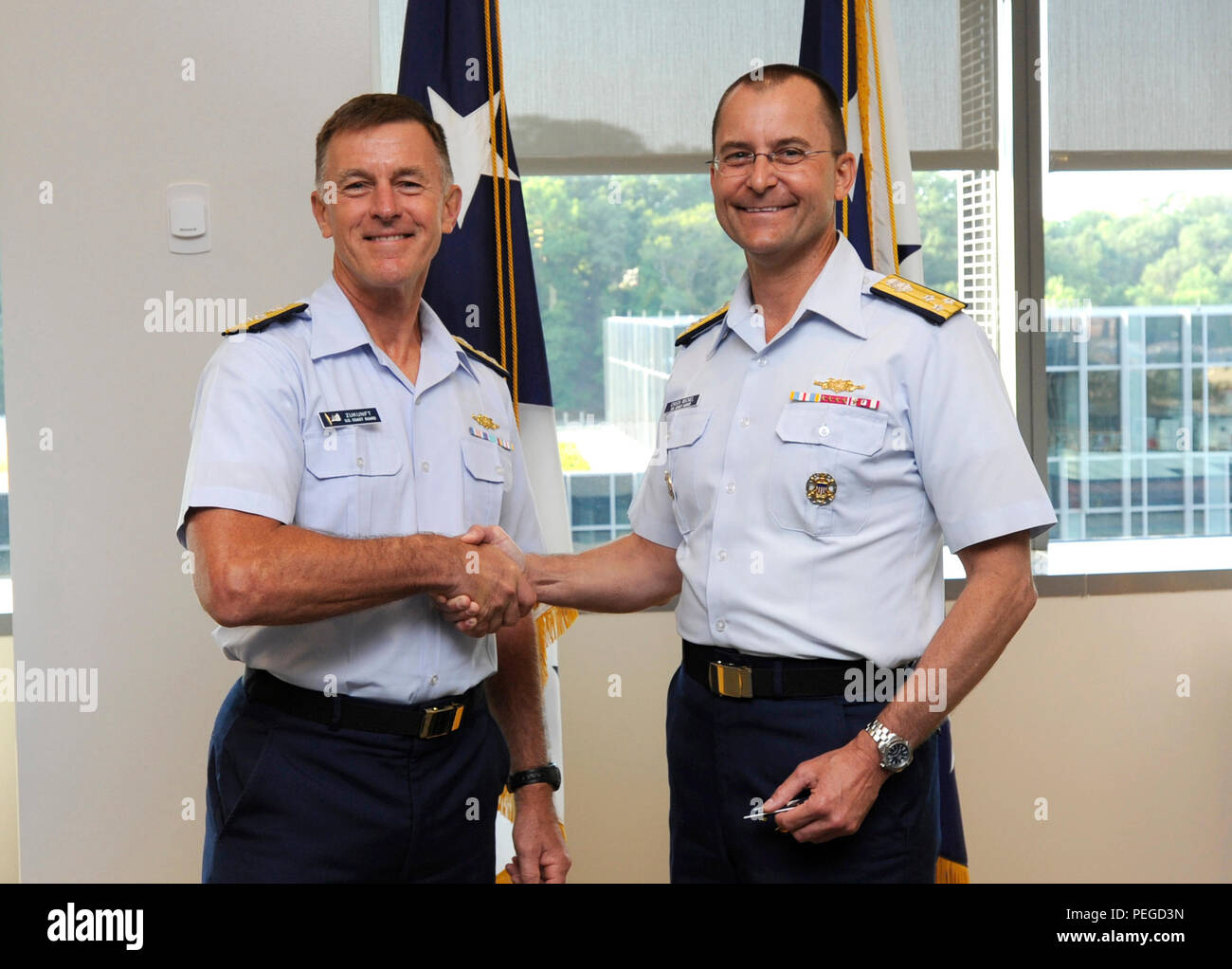 Adm. Paul F. Zukunft, commandant of the Coast Guard, shakes hands with ...