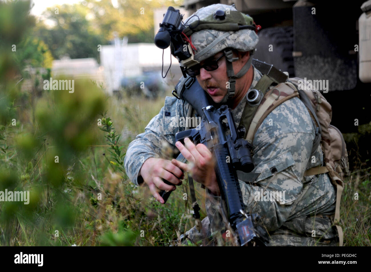 U.S. Army Reserve Soldier of the 461st Engineer Company reloads his ...