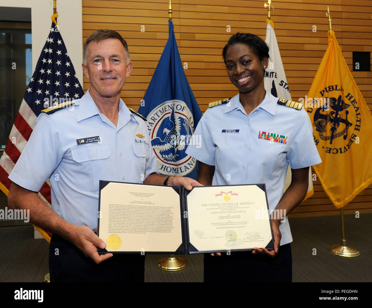 Adm. Paul F. Zukunft and Capt. Erica Schwartz hold Schwartz’s ...