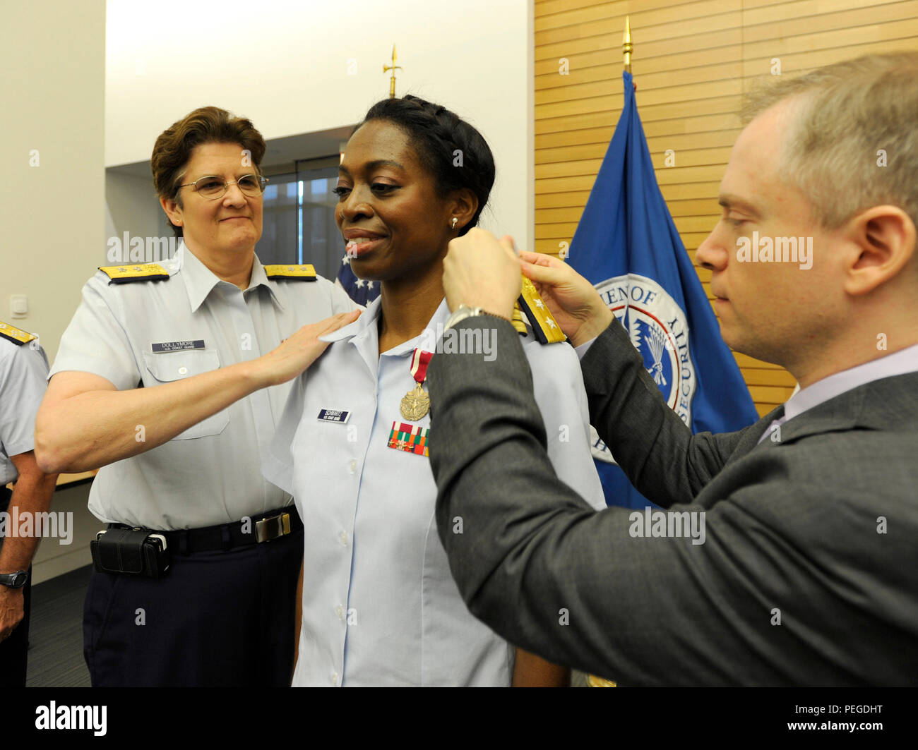 Rear Adm. Maura Dollymore and Daniel Schwartz affix new shoulder boards ...