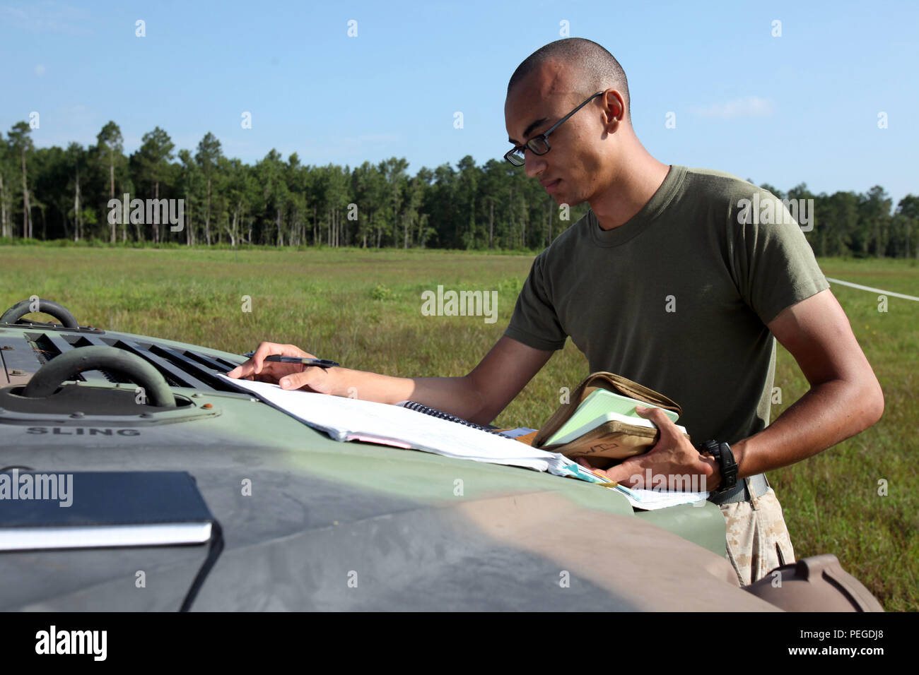 Lance Cpl. Nicholas Lewis goes over schematics for the equipment used ...