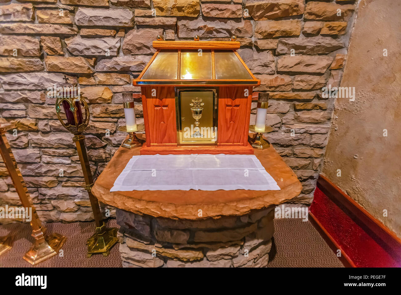 Donation box in a modern church with golden embellishments and locked ...
