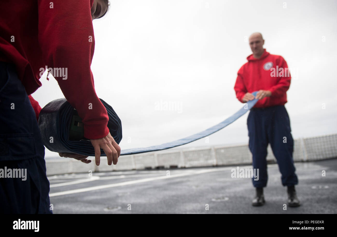 Petty Officers 1st Class Colin Edwards and Lisa Densmore roll a ...