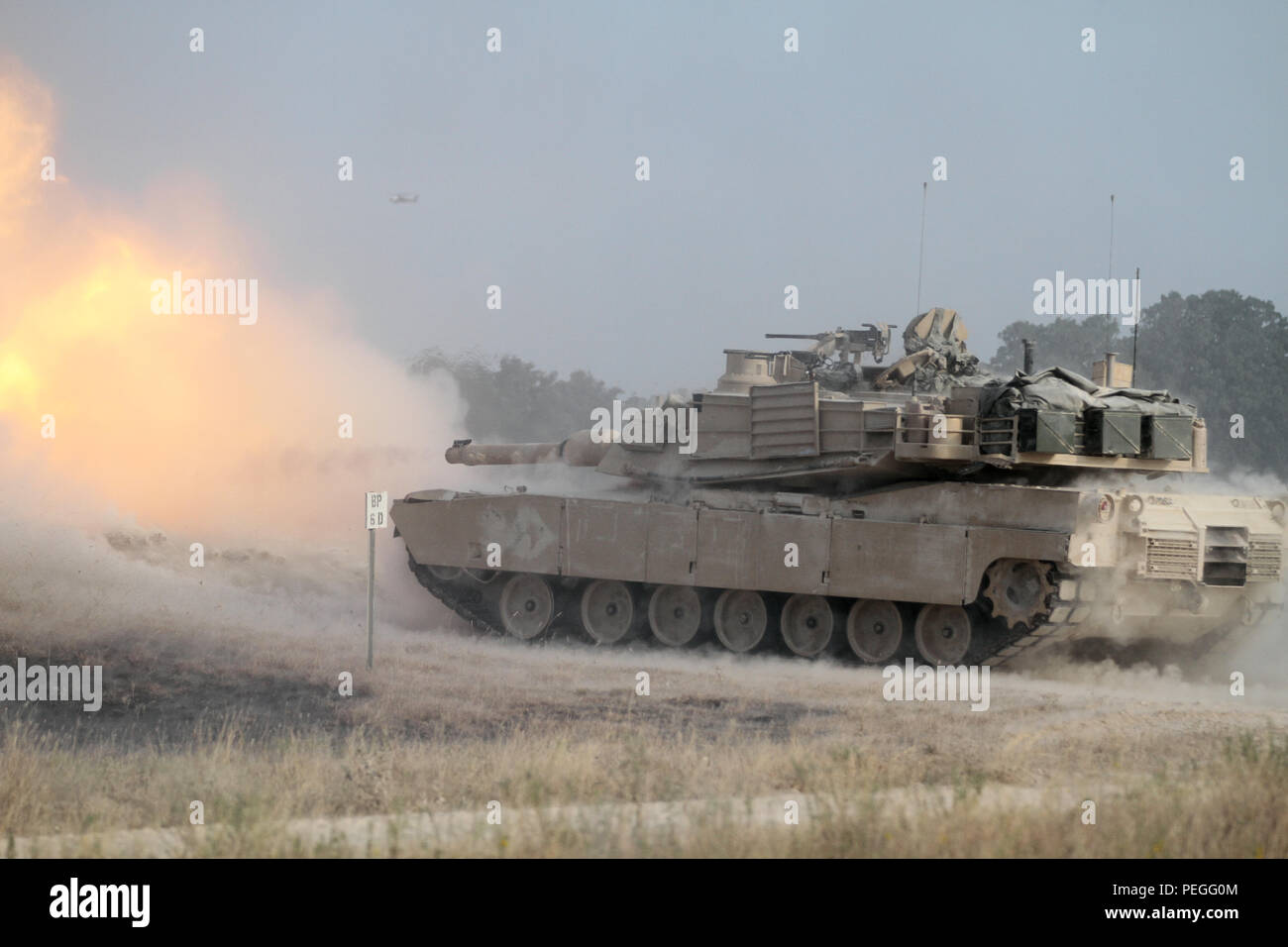 From a firing point, tankers in an M1A2 Abrams Main Battle Tank fire ...
