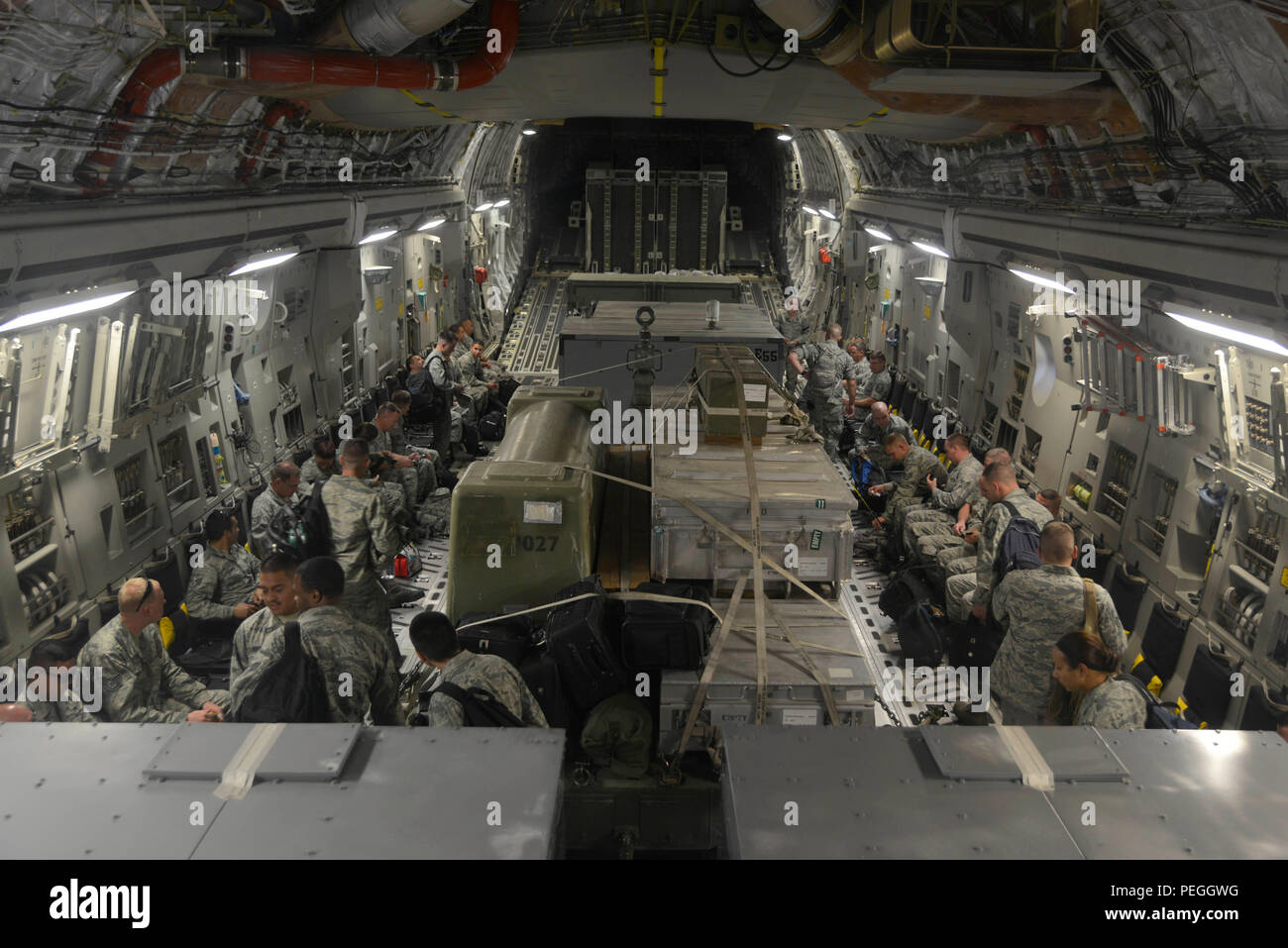 Airmen assigned to the 144th Fighter Wing board a C-17 Globemaster III ...