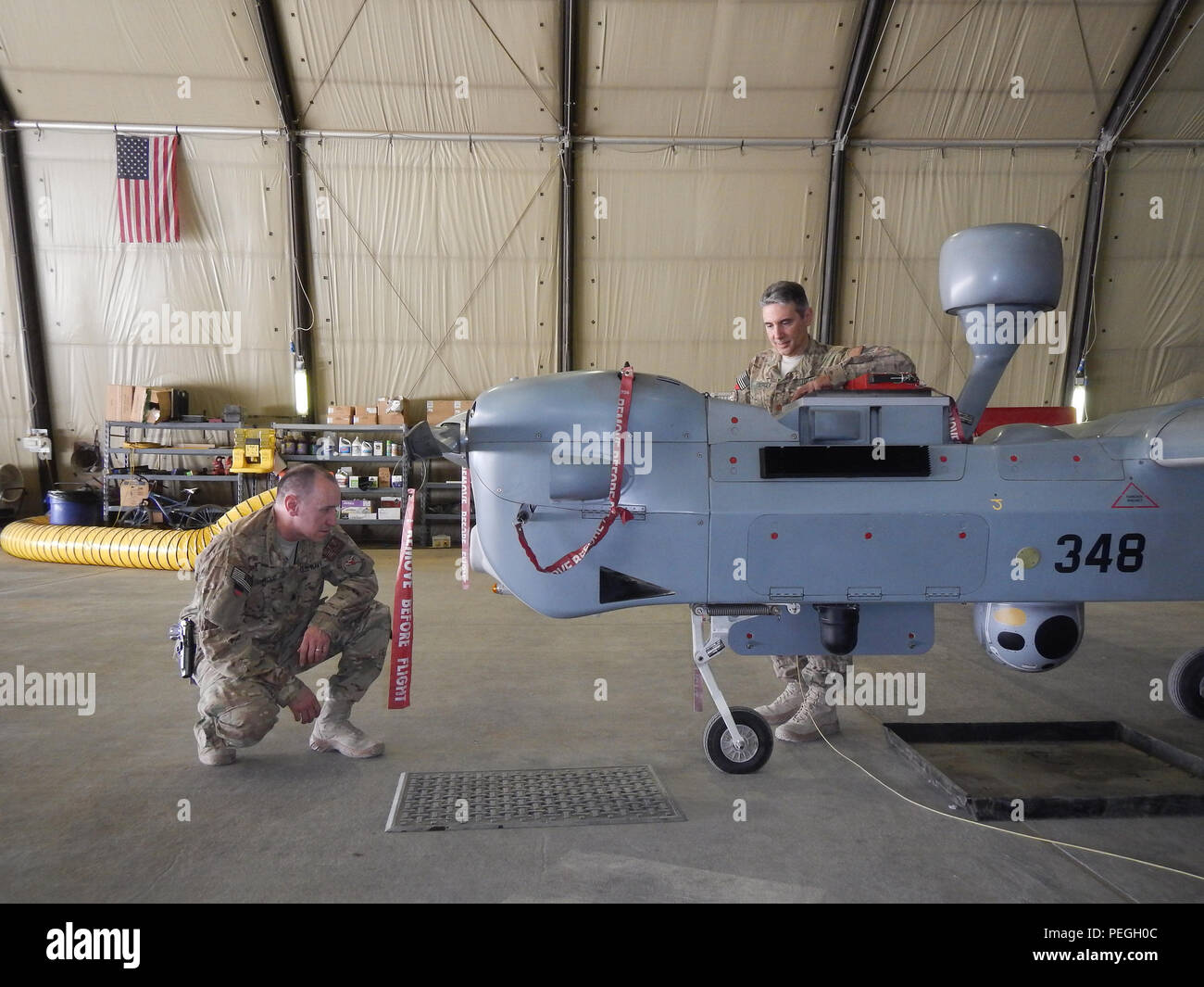 At Kandahar Airfield, U.S. Navy personnel operate and inspect the MQ-5B ...