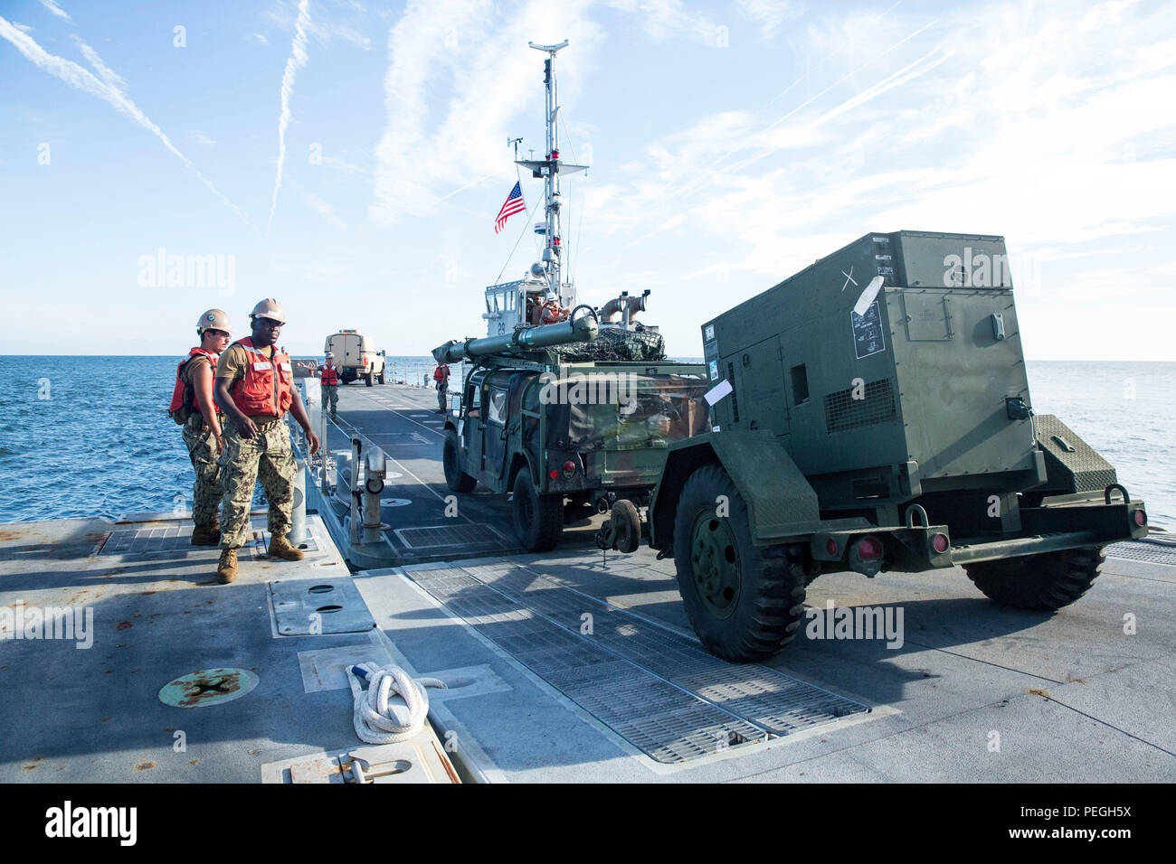 A Marine with Combat Logistics Regiment 25 drives a High Mobility ...