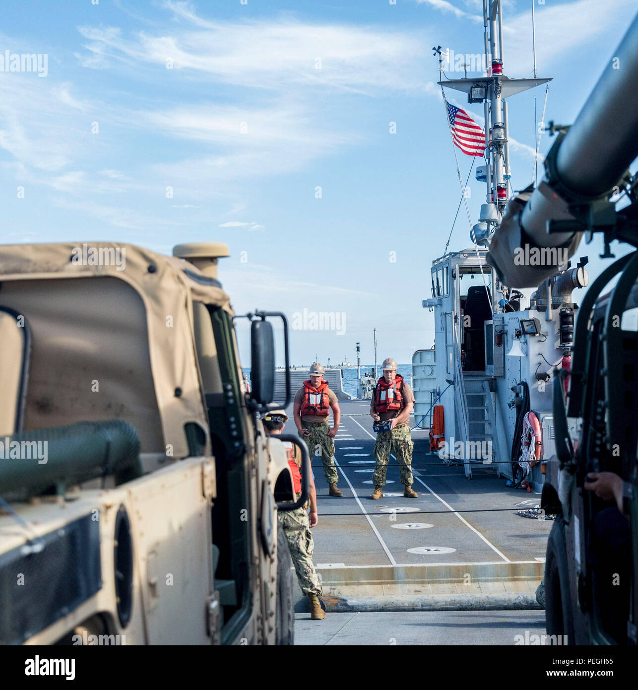 A sailor attached to Naval Beach Group 2 uses a joystick to steer an ...