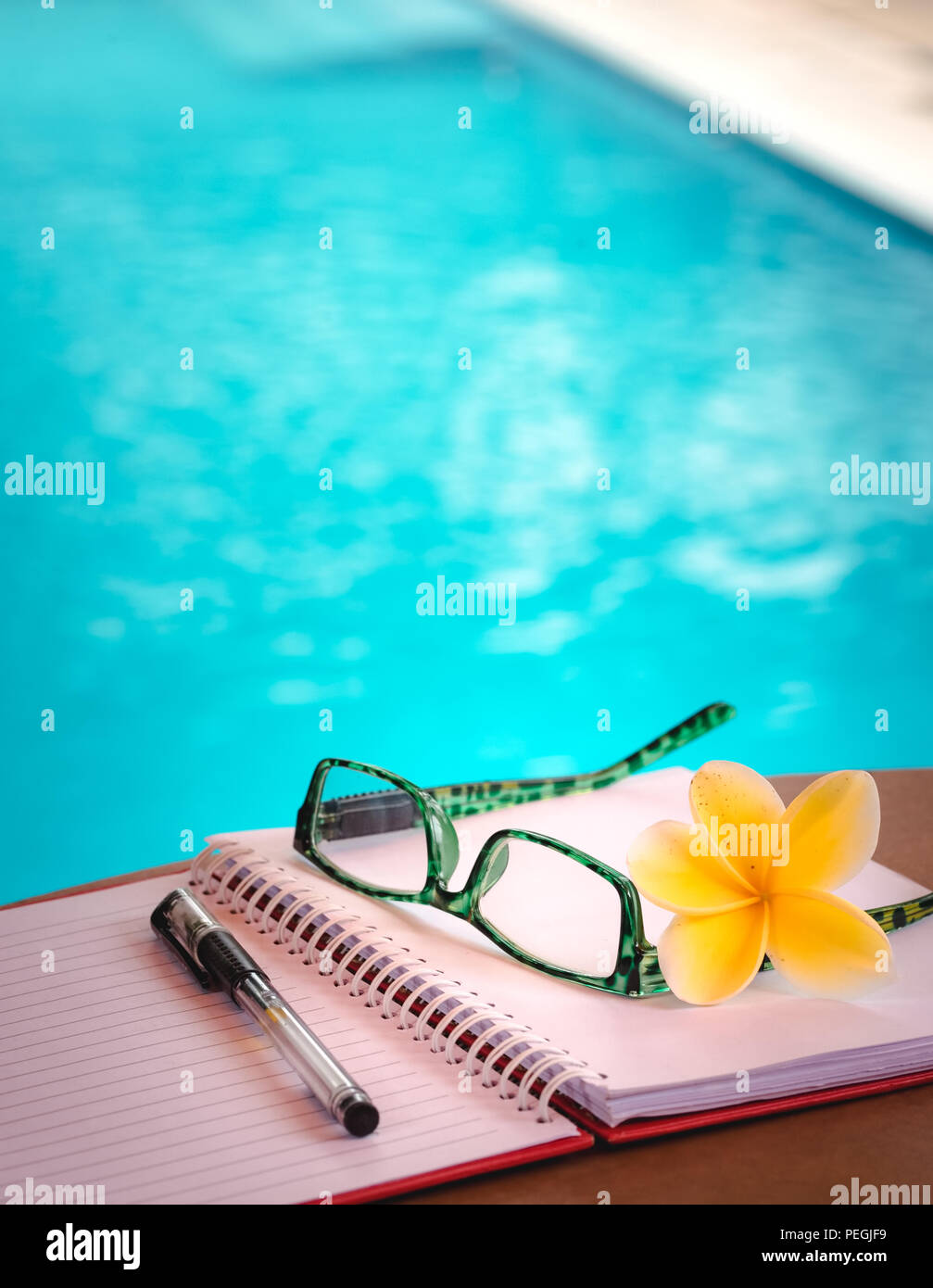 Open Book, Pen and Glasses on The Table Beside Swimming Pool. Working ...