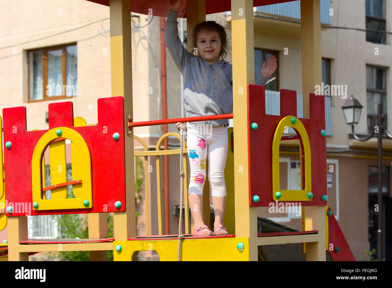 Little children run around and play in the playground. Game center for ...