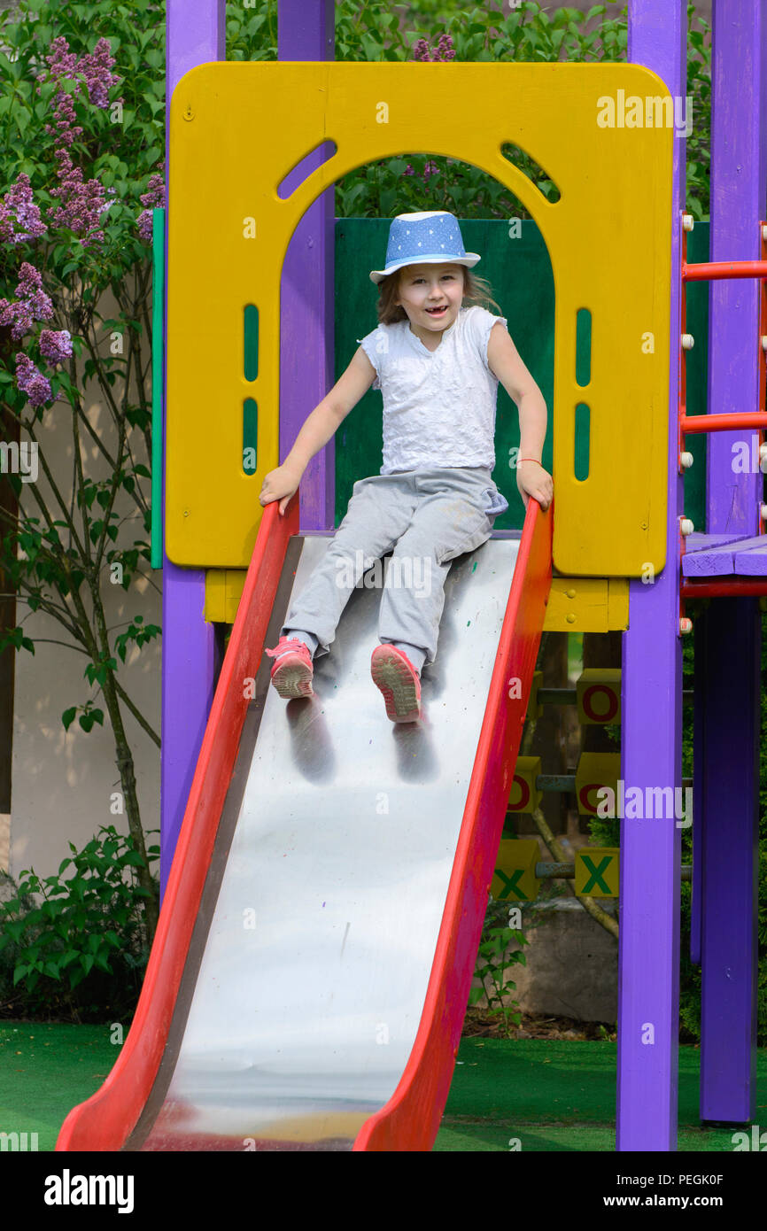 Little children run around and play in the playground. Game center for ...