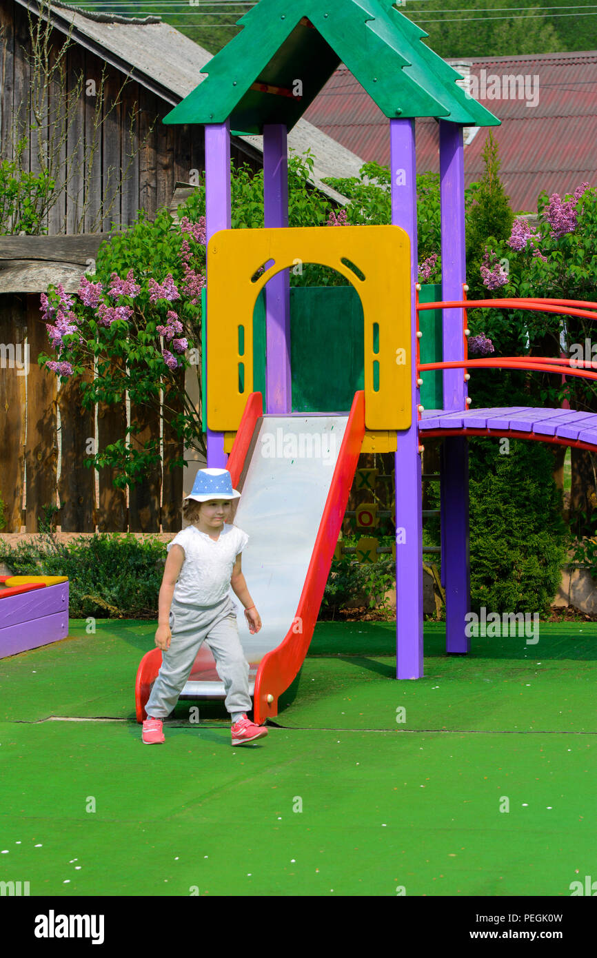 Little children run around and play in the playground. Game center for ...