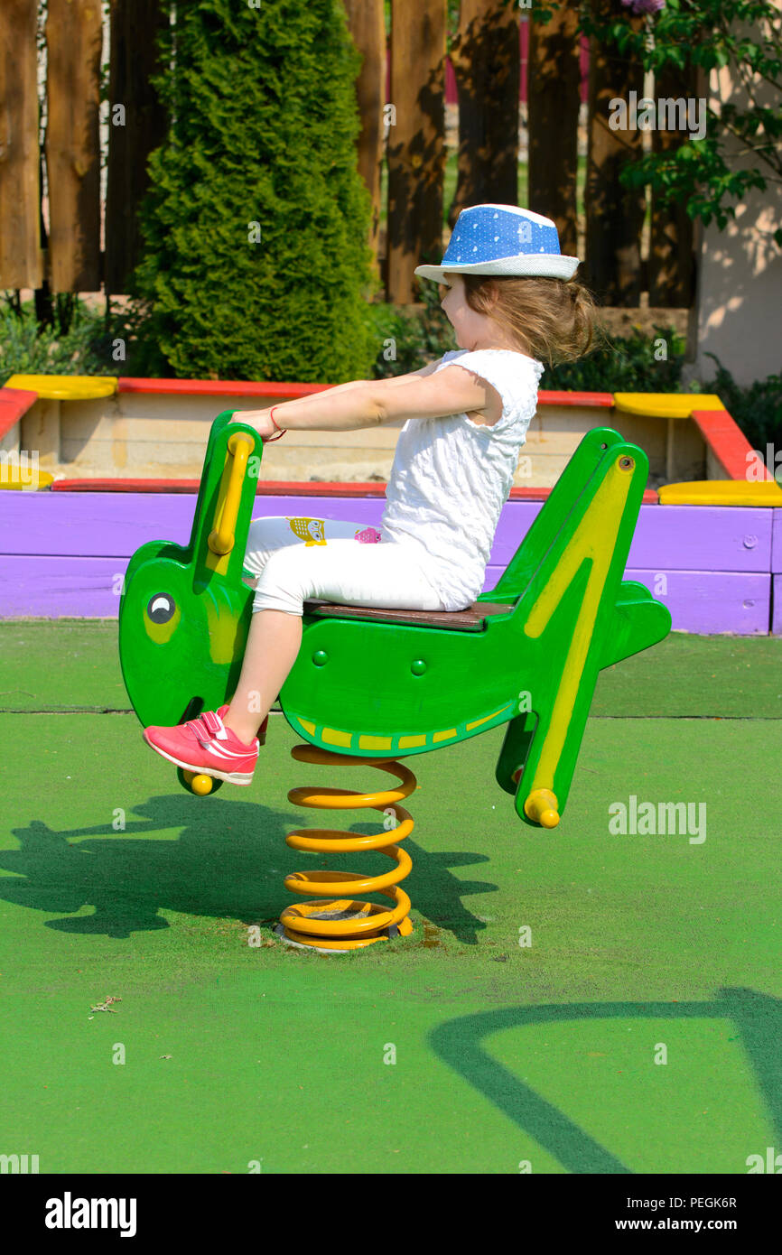 Little children run around and play in the playground. Game center for ...