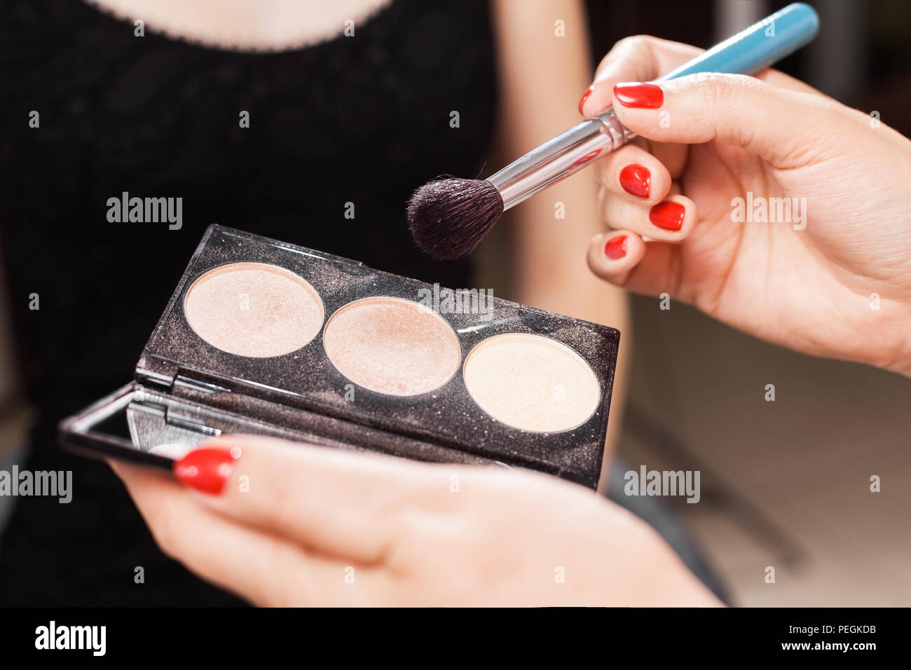 makeup artist mixing powder concealers in a palette Stock Photo - Alamy