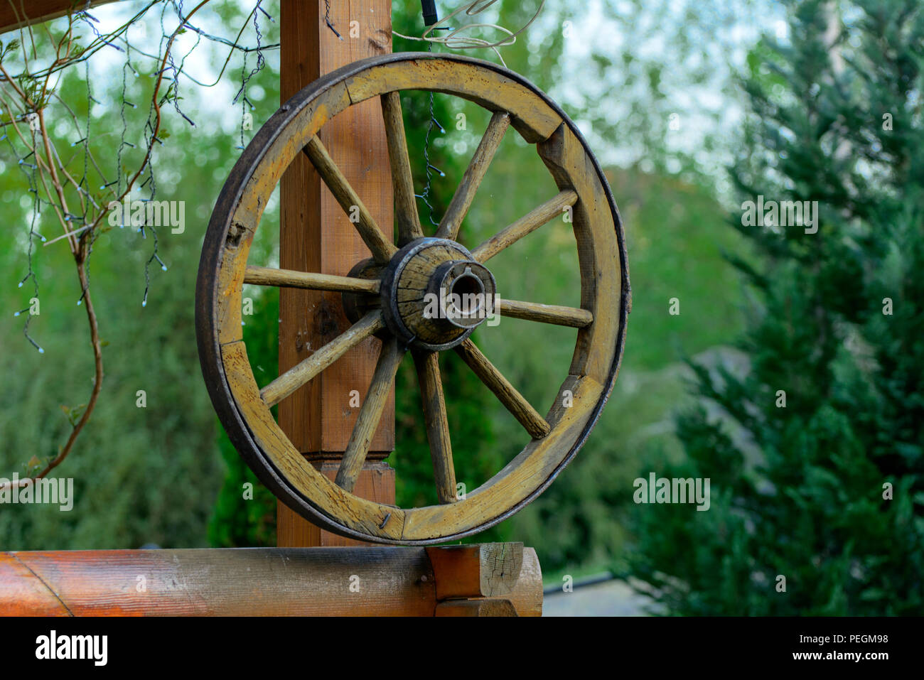 Wheel of the past. An ancient old wooden wheel from a rural cart is ...