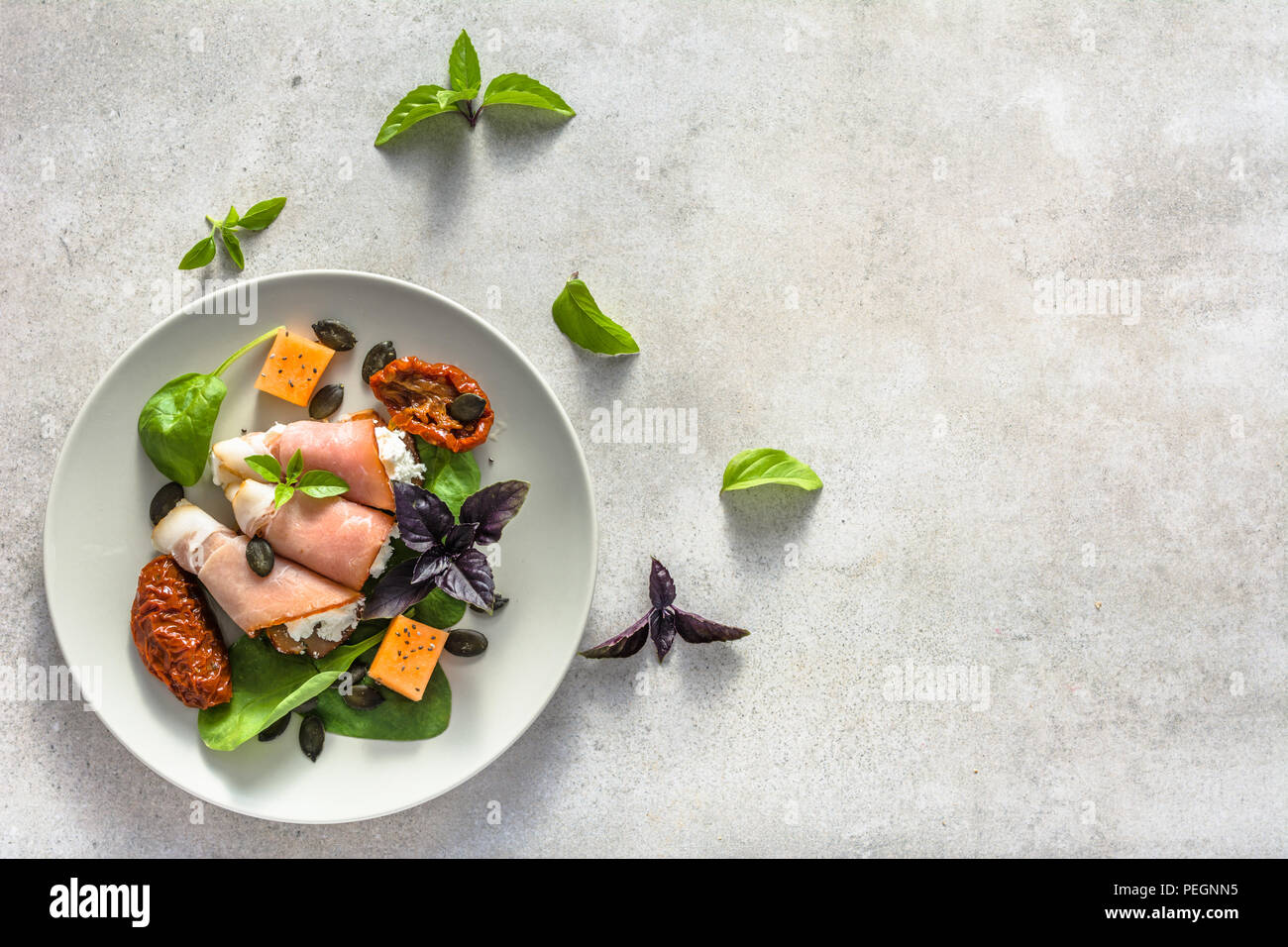 Italian food on plate, appetizer with prosciutto and cheese. Antipasti ...