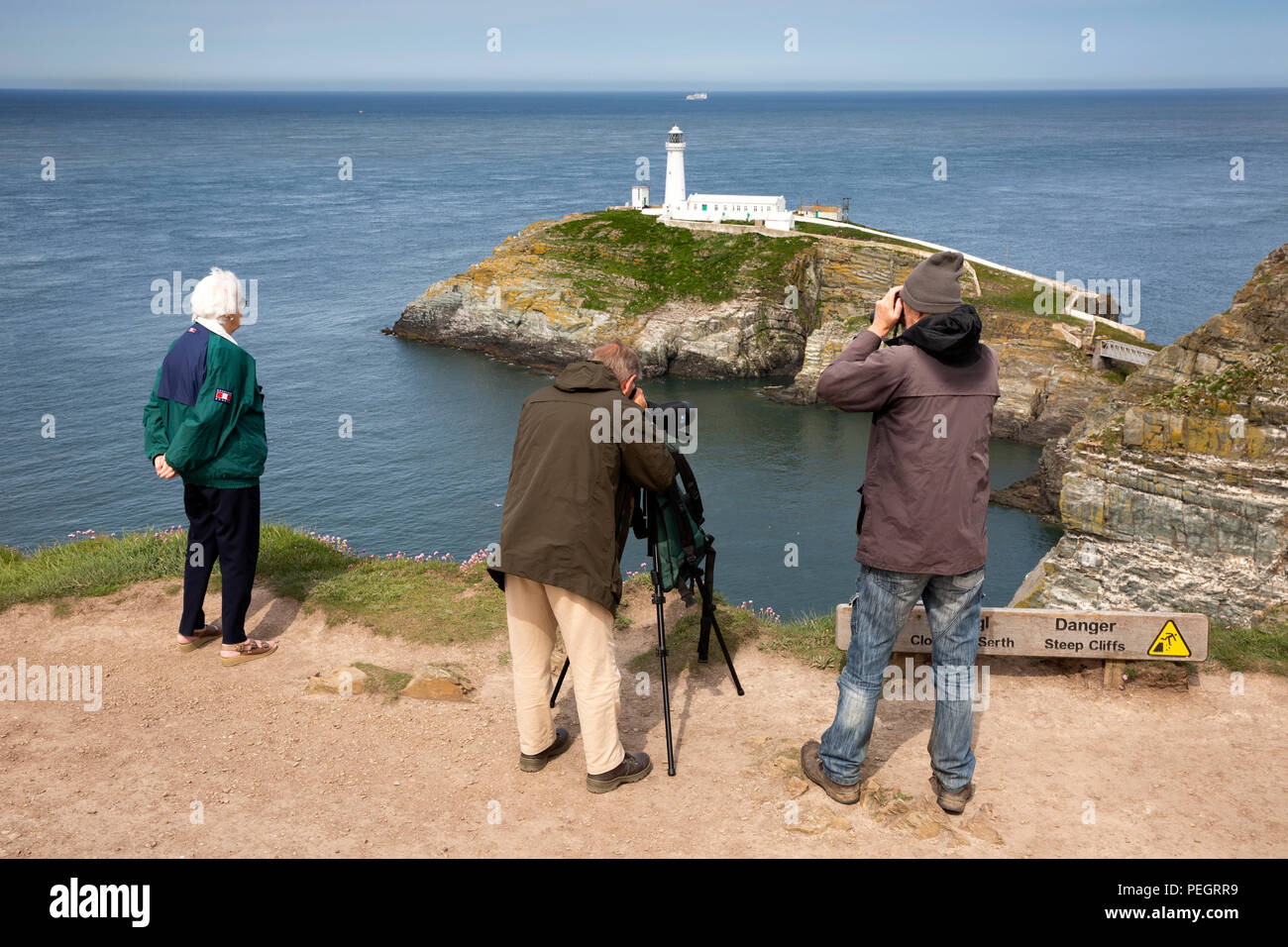 UK, Wales, Anglesey, South Stack, birdwatchers at RSPB Ellin’s Tower ...