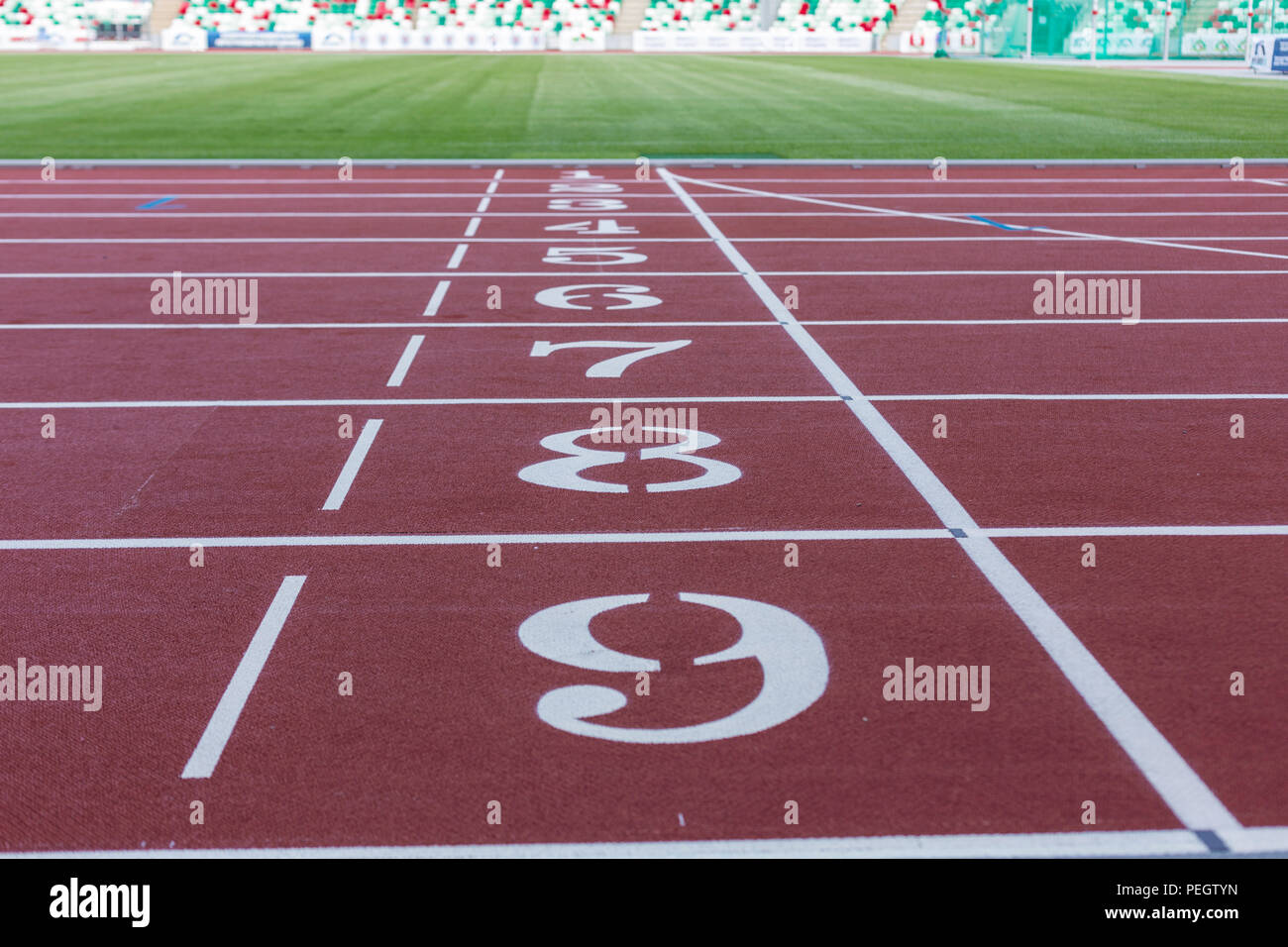 Red sport track for running on public stadium. Running healthy ...