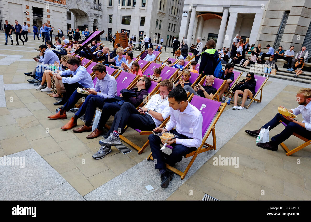 office workers having lunch sitting in deckchairs, paternoster square ...