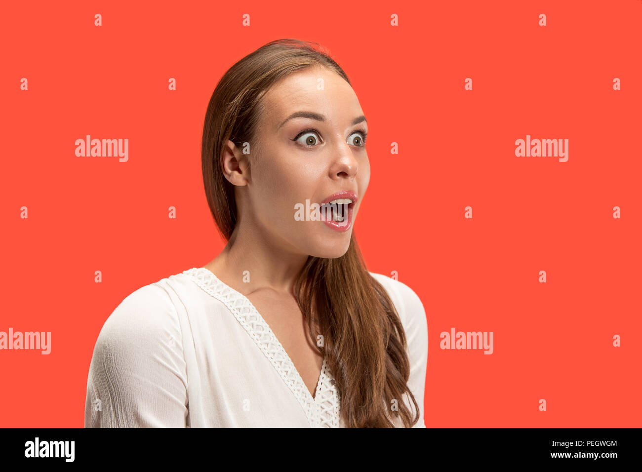 Delight. Beautiful female half-length front portrait isolated on red ...