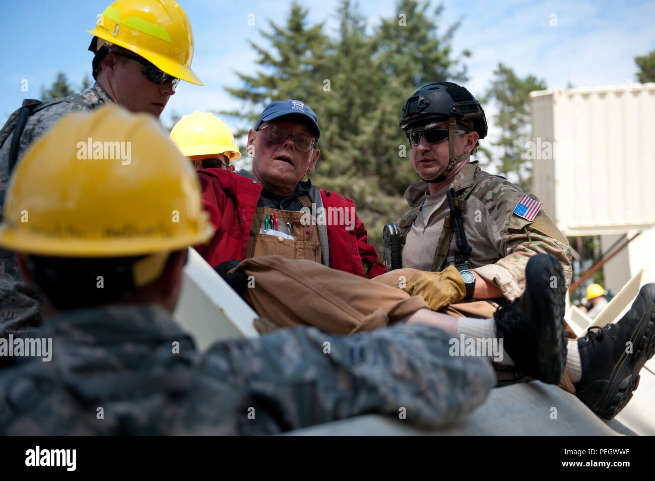 First responders assist a simulated survivor from the rubble of a ...