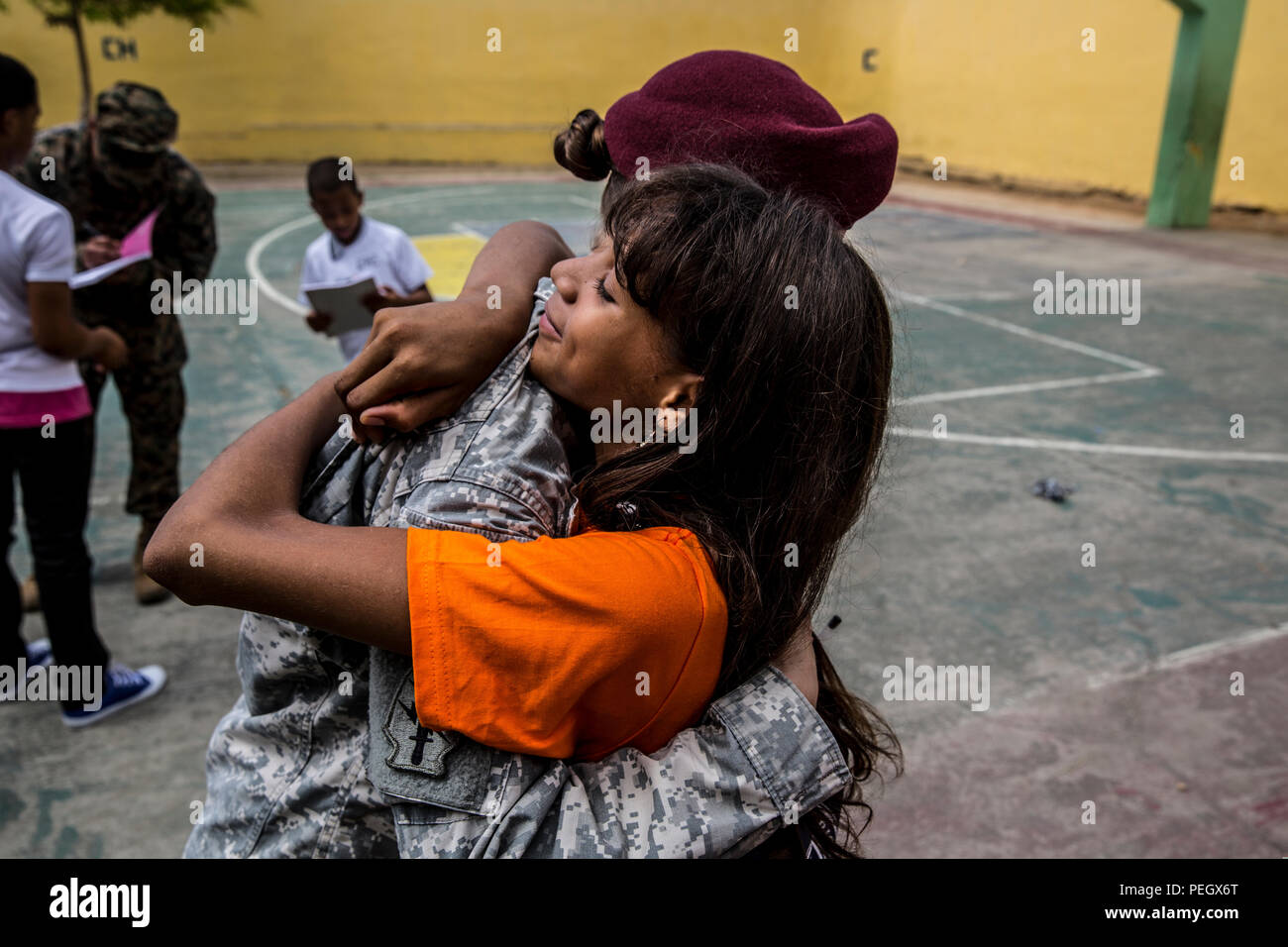 U.S. Army Capt. Lesley Fisher, a civil affairs officer, embraces a ...