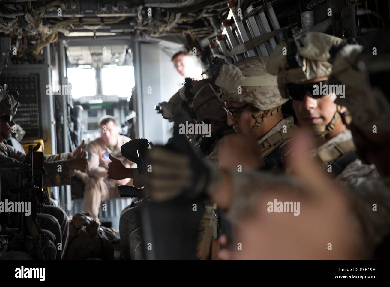 Marines with 2nd Battalion, 1st Marine Regiment, put their thumbs up ...