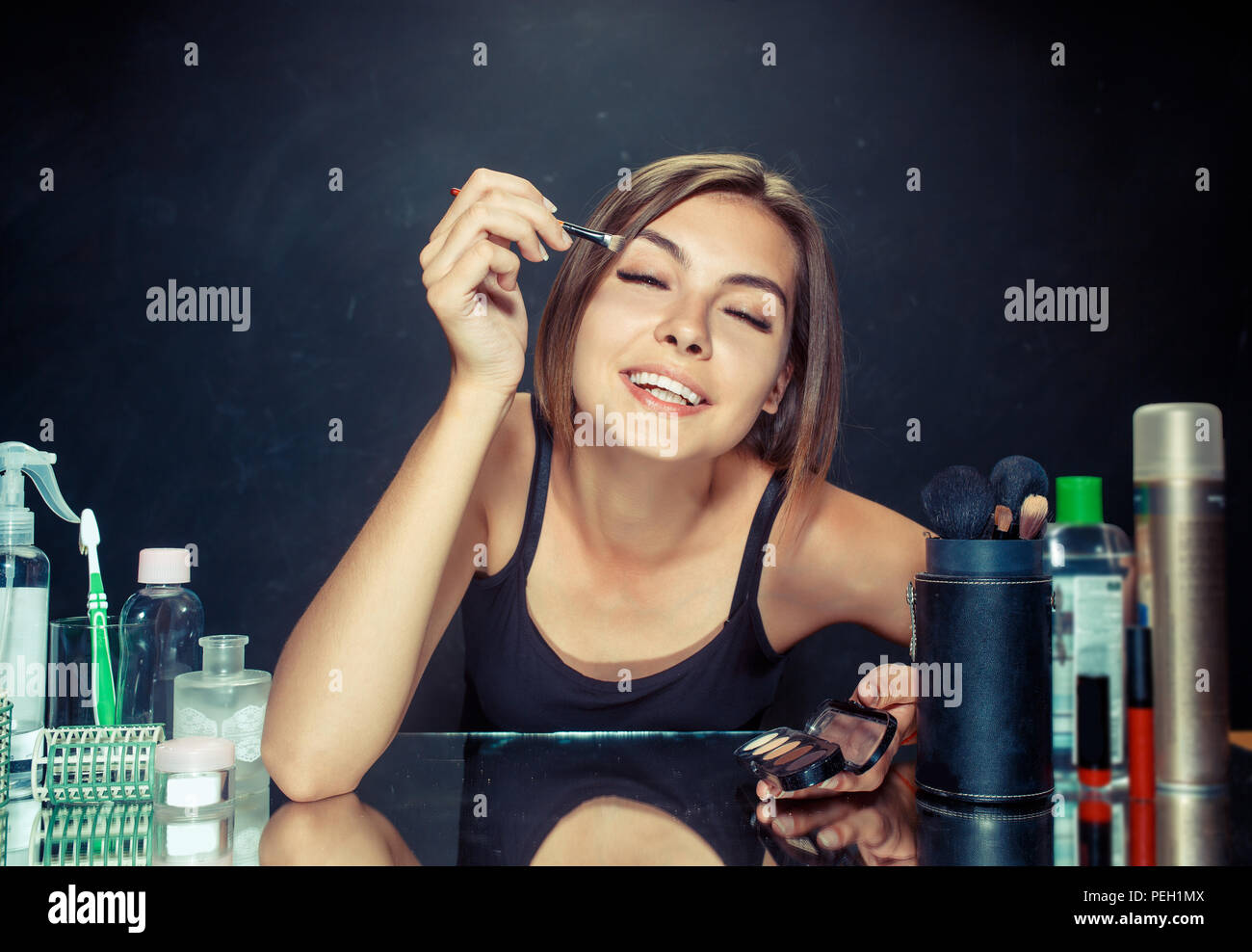 Beauty Woman Applying Makeup Beautiful Girl Looking In The Mirror And Applying Cosmetic With A