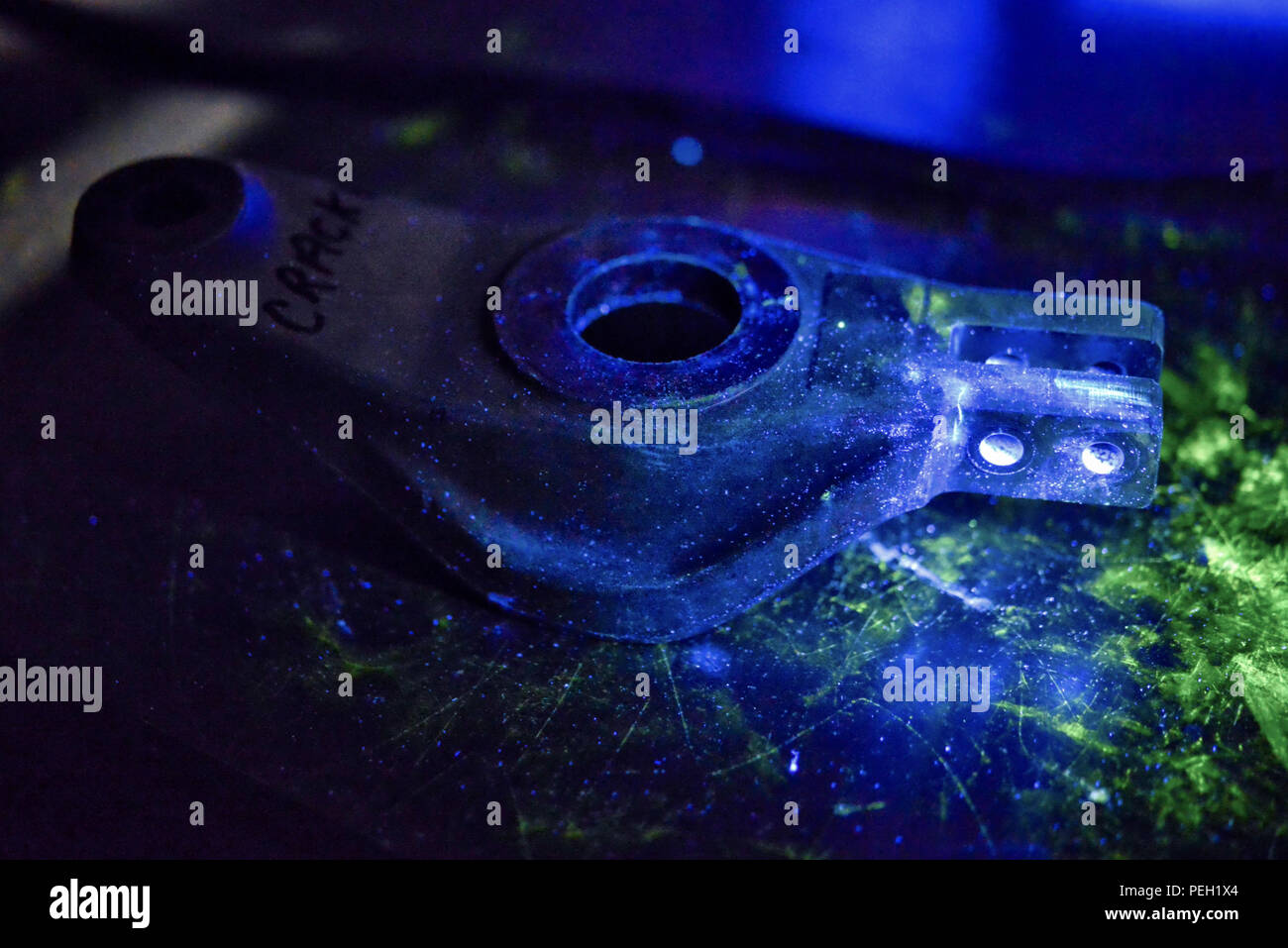 A metal training equipment piece sits under a black light during a ...